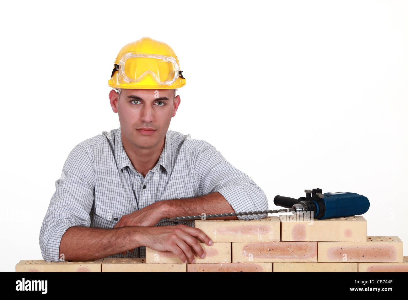 A mason posing by a wall Stock Photo - Alamy