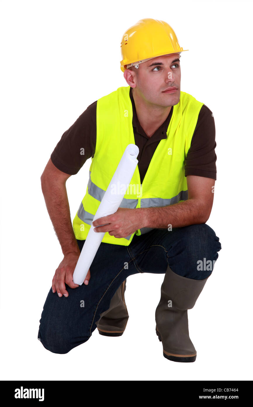 Engineer in a reflective vest with plans Stock Photo - Alamy