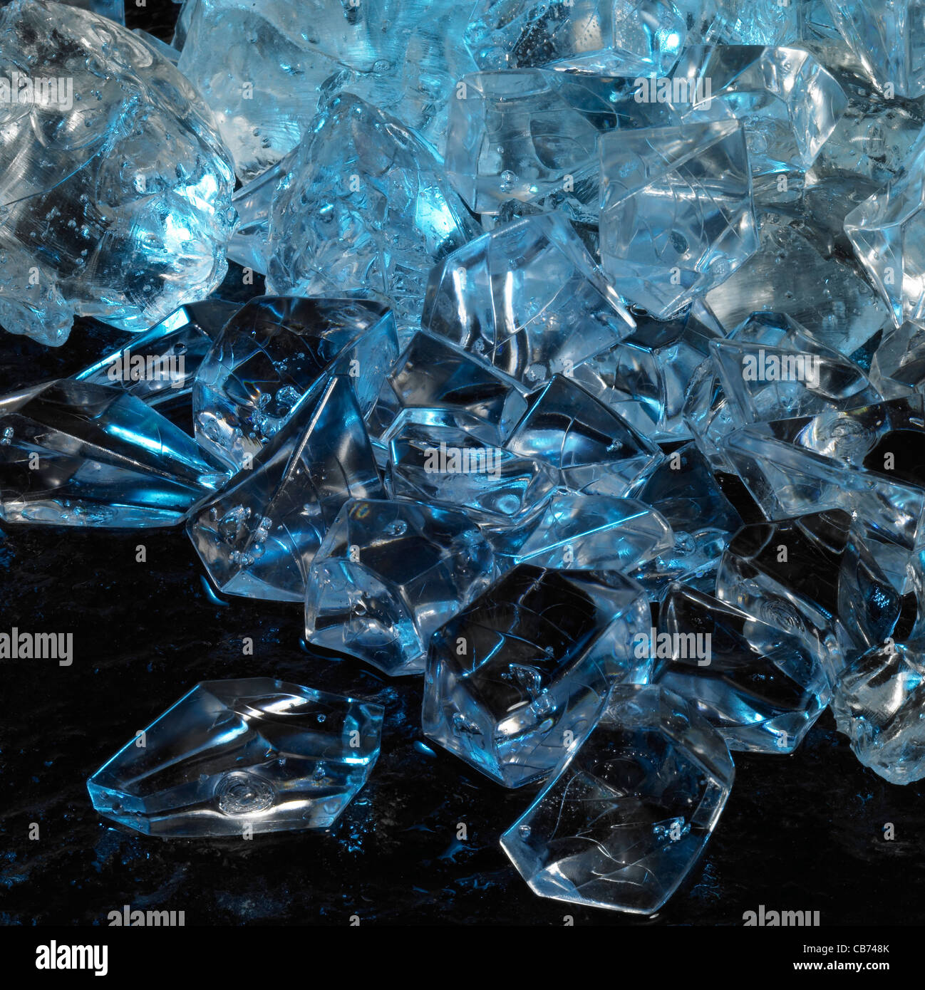 studio photography of blue illuminated ice cubes in dark back Stock ...