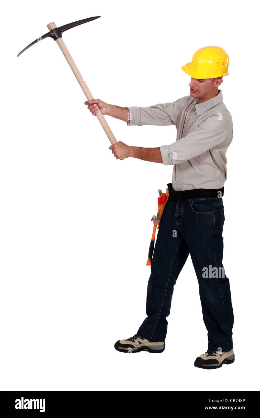 Man using pick-axe Stock Photo - Alamy