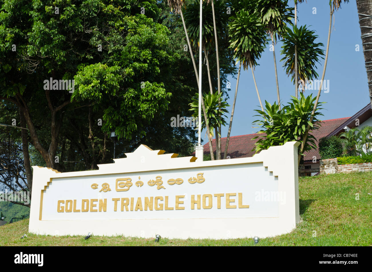 Large white and gold sign for Golden Triangle Hotel on hilltop with ...