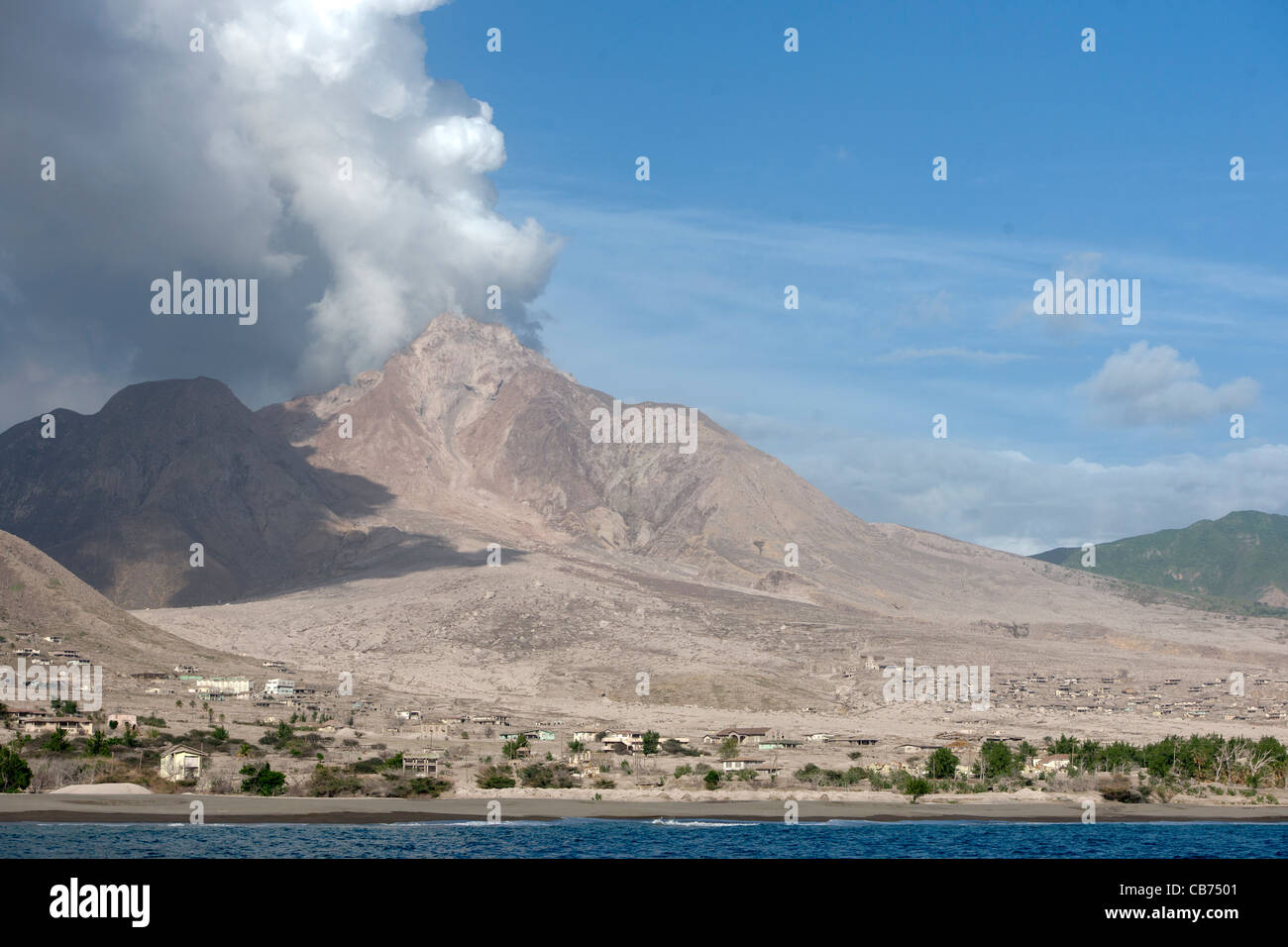 Smoking Soufriere Hills Volcano, ruined former capital city of Plymouth ...