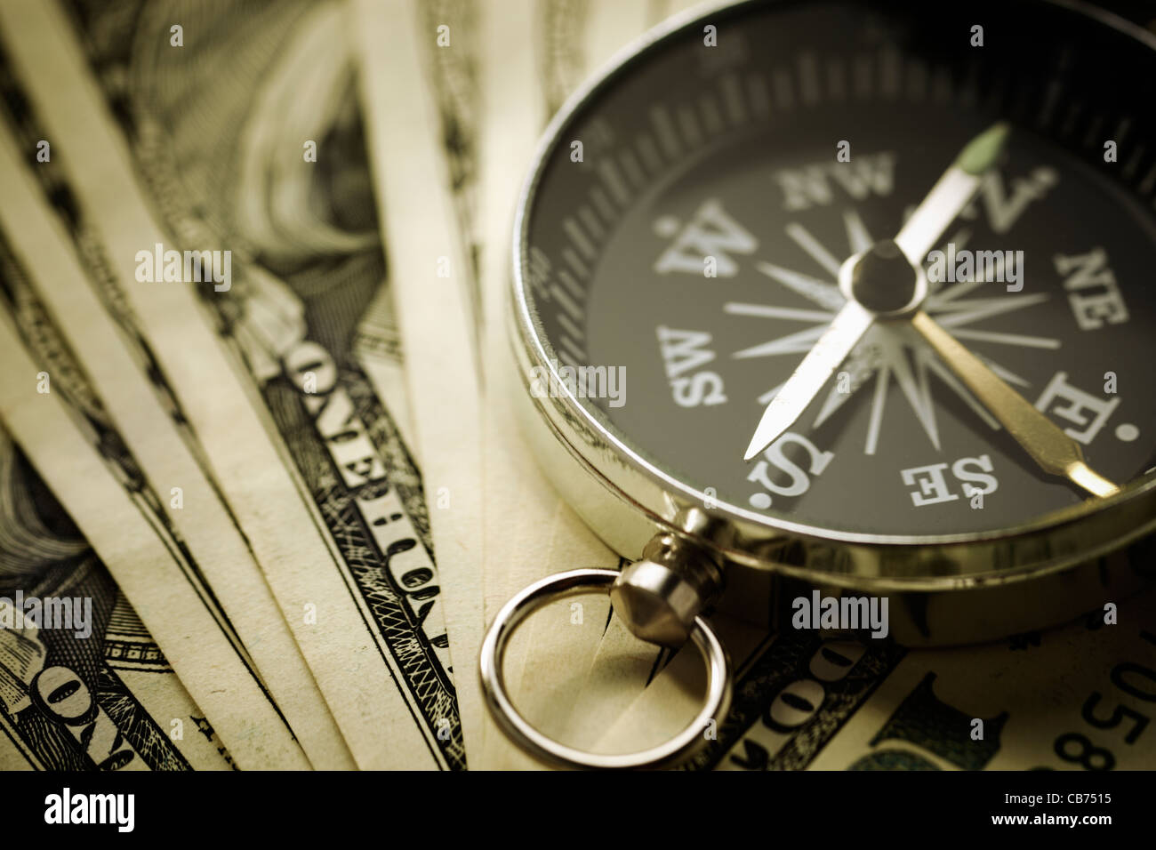 money and compass, selective focus on nearest part of arrow Stock Photo ...