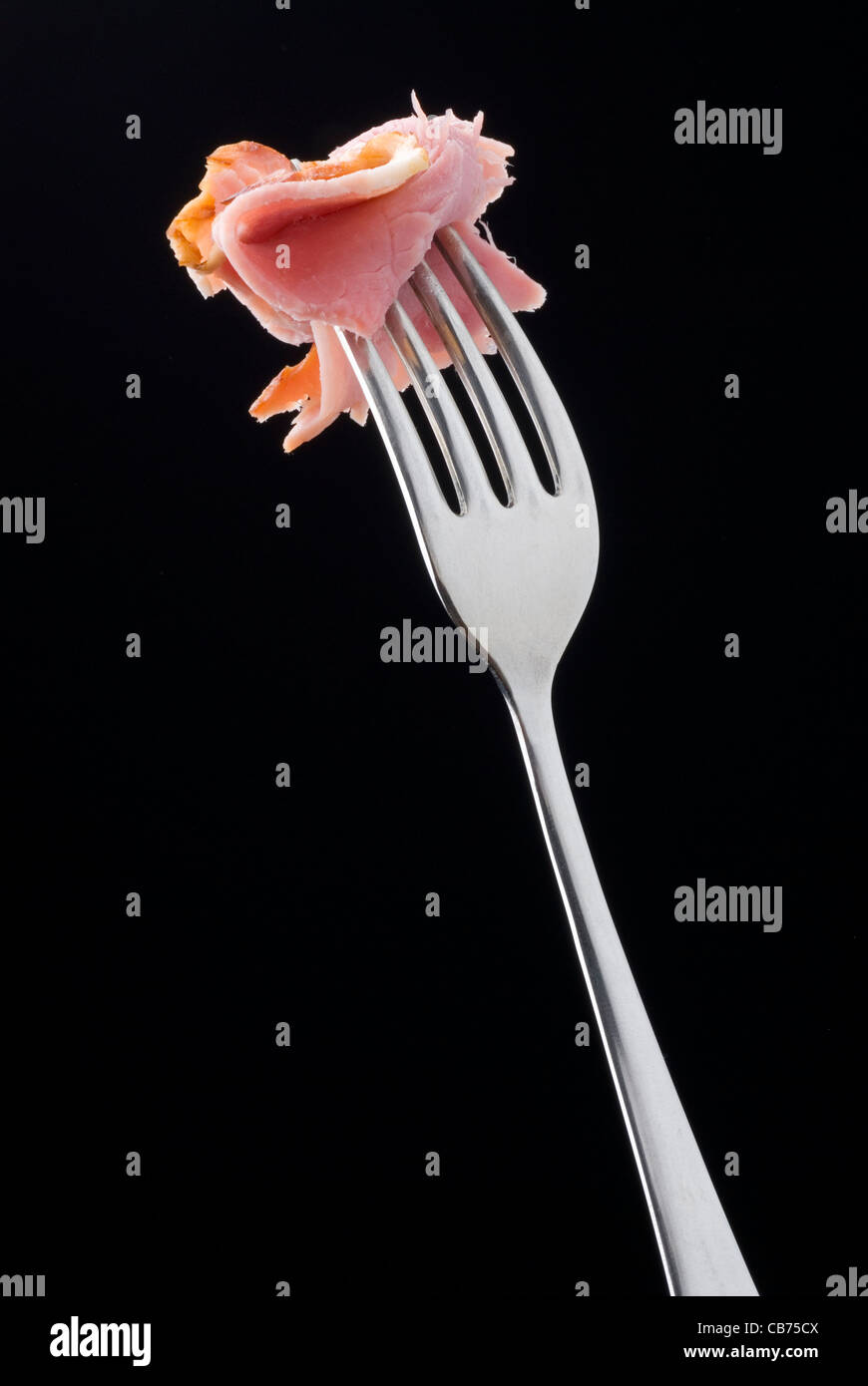 delicious mouthful of ham fork Stock Photo - Alamy