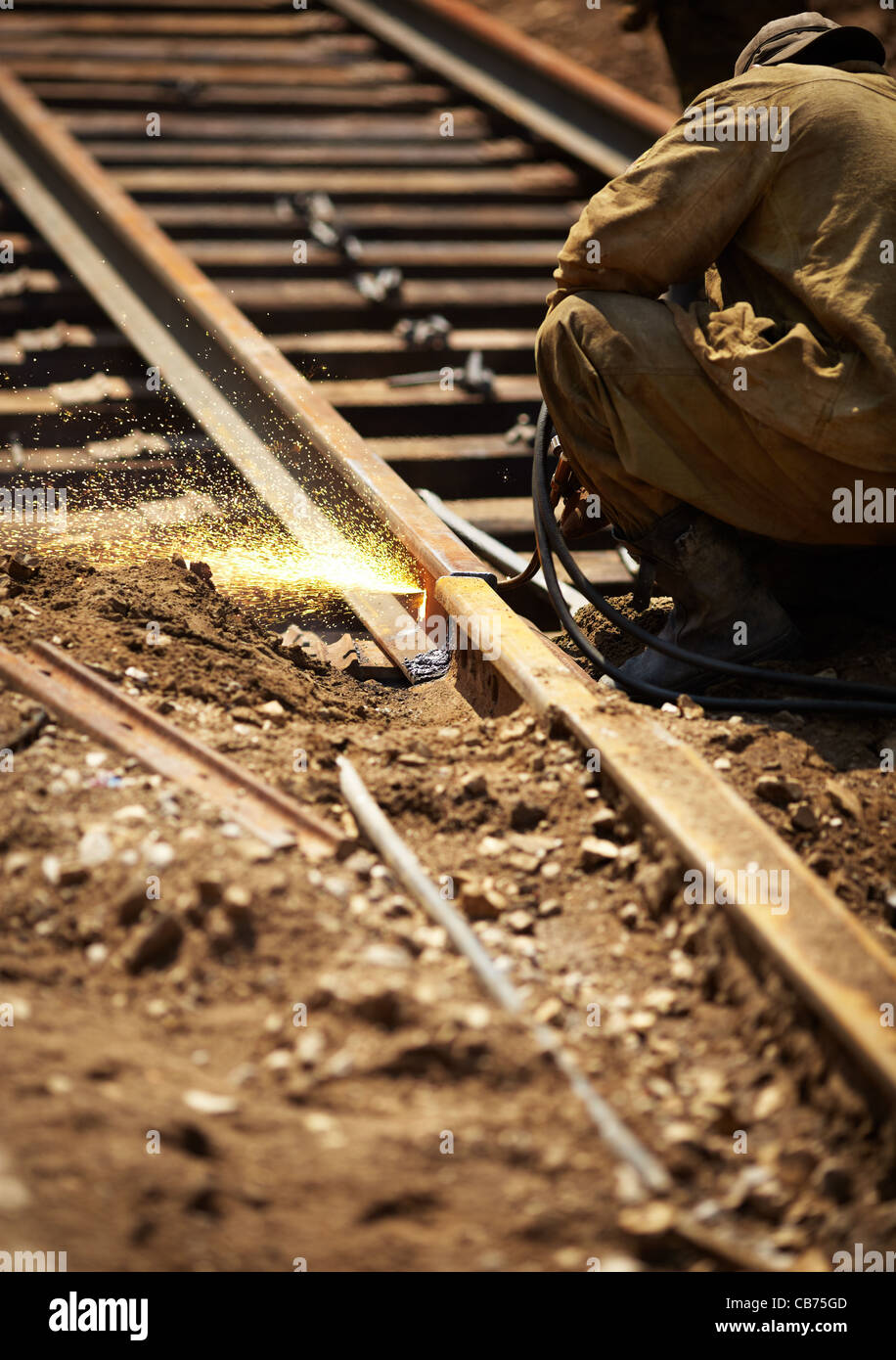 worker cutting through a railroad track , selective focus Stock Photo ...
