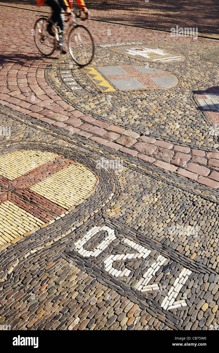 Cyclist passing by the historical pavement at the city center. Freiburg ...