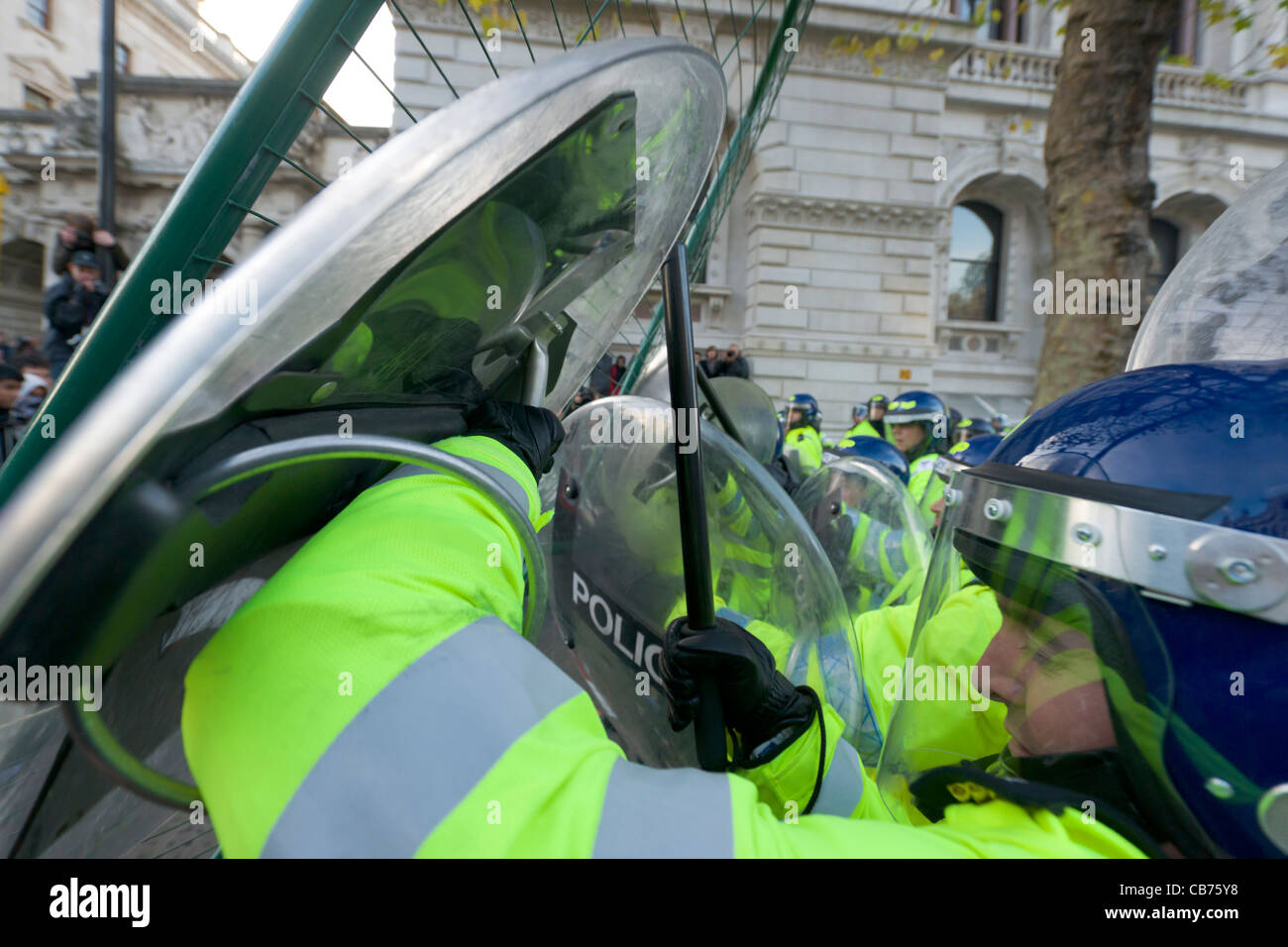 Police in riot gear fending of barrier thrown by protestors on ...