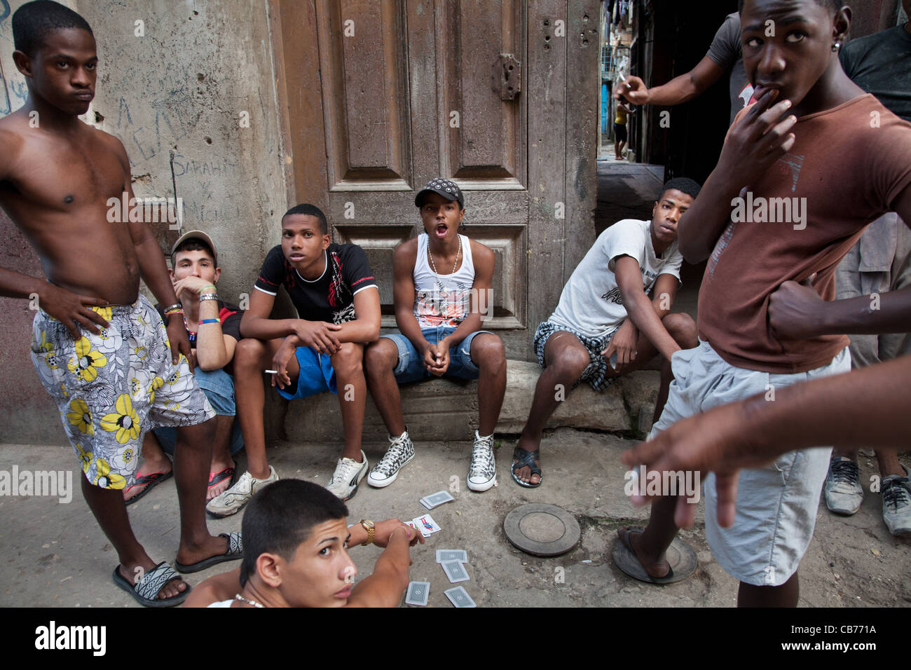 Youth gang playing cards in front of a house. Havana (La Habana), Cuba ...