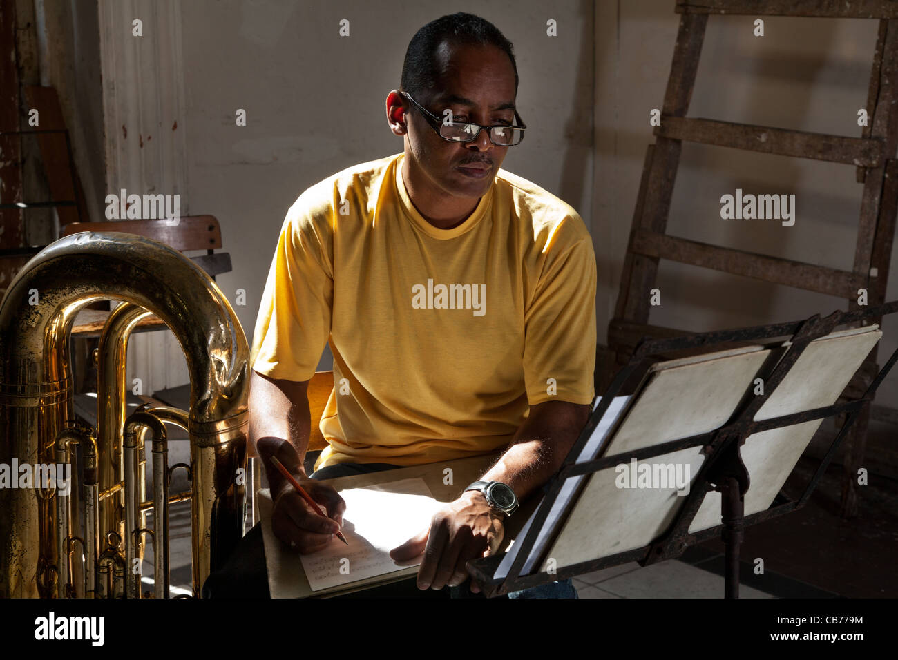 A tuba player taking notes in the Asociacion Rosalia de Castro, Havana ...