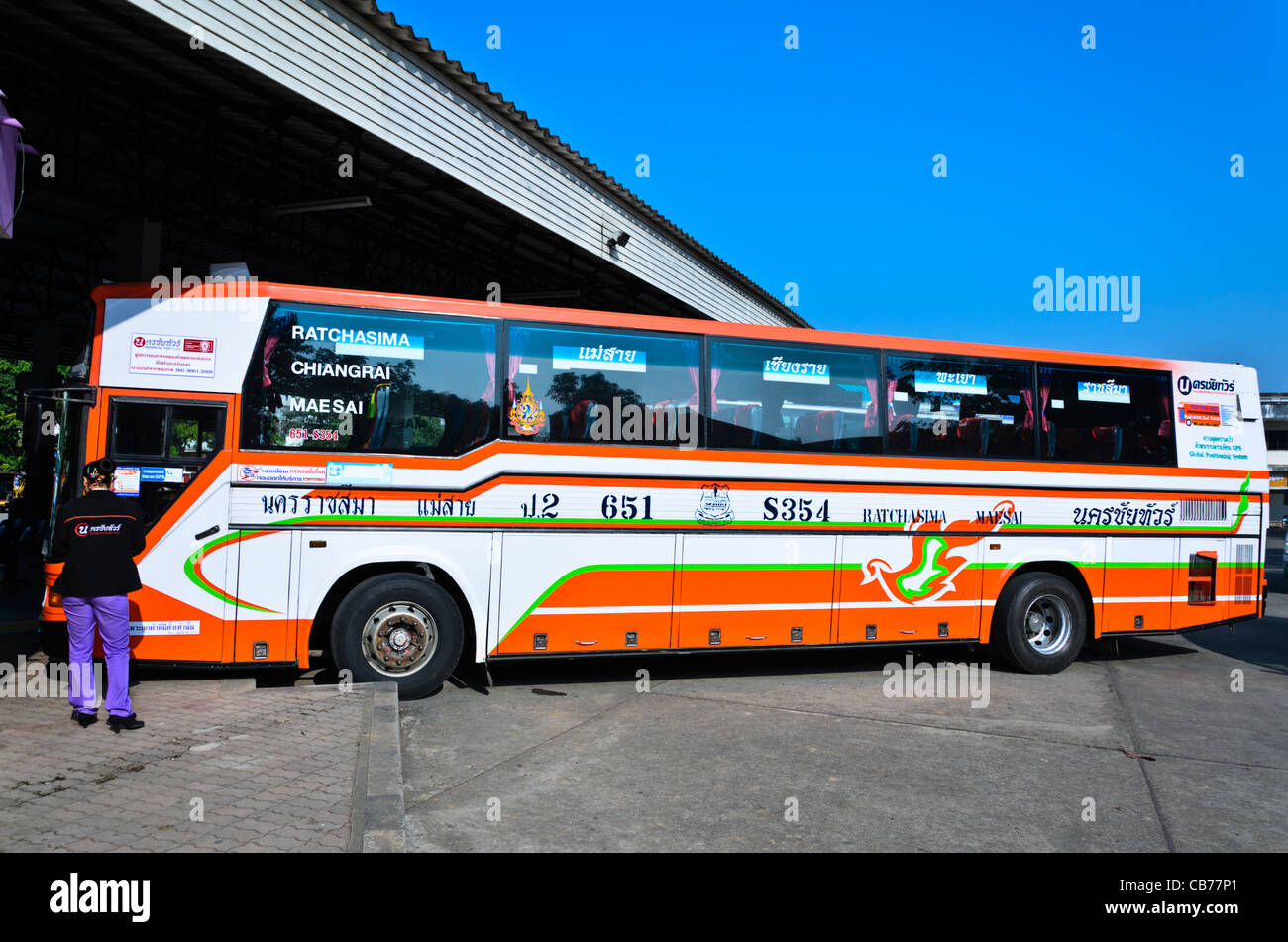 Colorful orange, white and green bus in sunshine at Mae Sai bus station ...