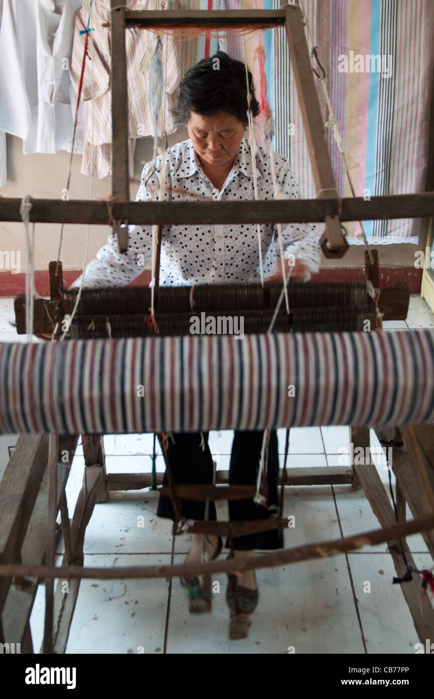 A woman works on an old loom, Zhujiayu, Zhangqiu District, Shandong ...