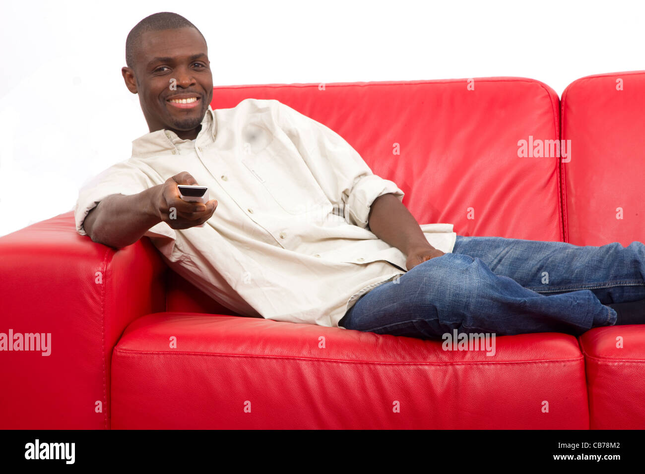 man on the sofa with remote control Stock Photo - Alamy