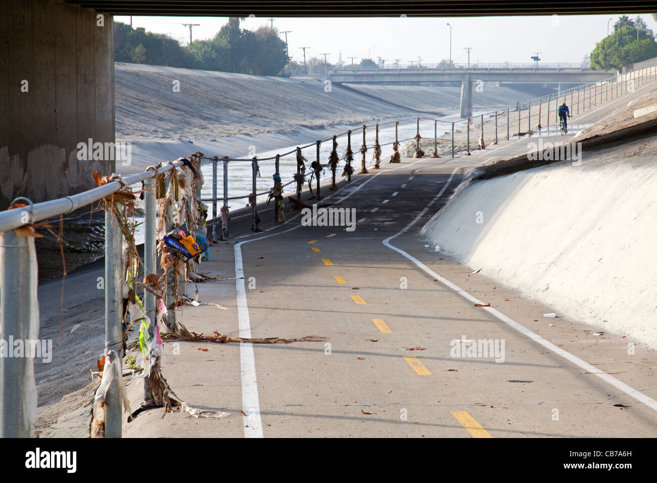 Plastic bags and other debris catch onto railing of bike path after a ...