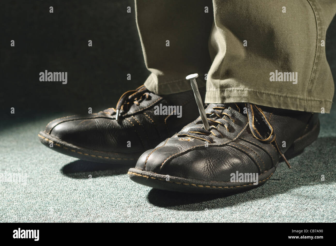 nail spike piercing shoe and foot holding man in place Stock Photo - Alamy