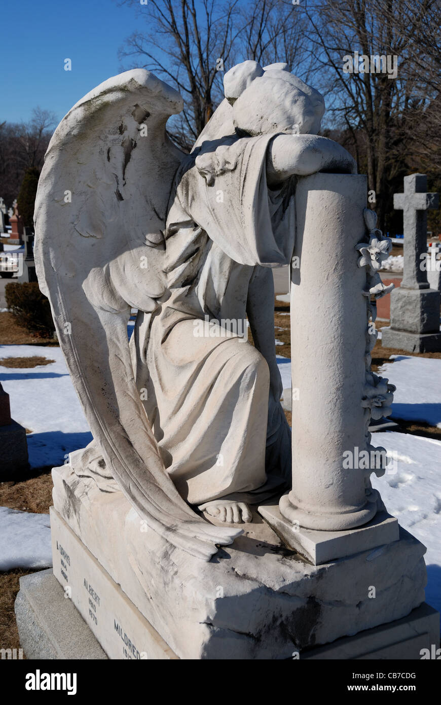 An elaborate and detailed graveyard monument of an angel weeping Stock ...