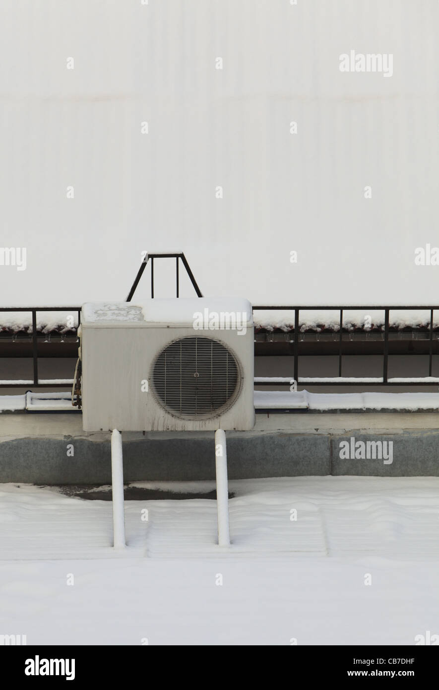 Image of an air conditioner machine on a roof of a building covered by ...