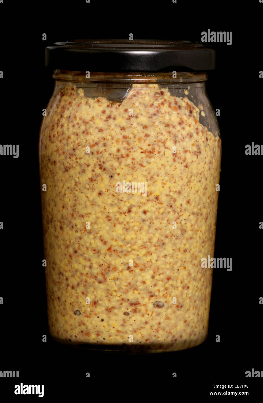 wholegrain mustard on a black background Stock Photo - Alamy