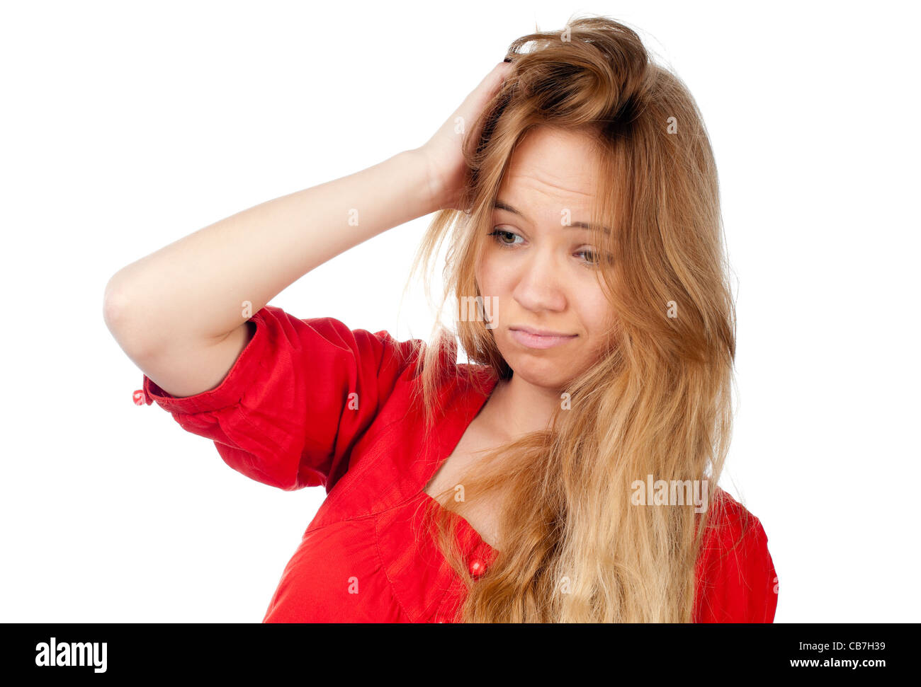 beautiful confused teenage girl with hand in her hair, looking away ...
