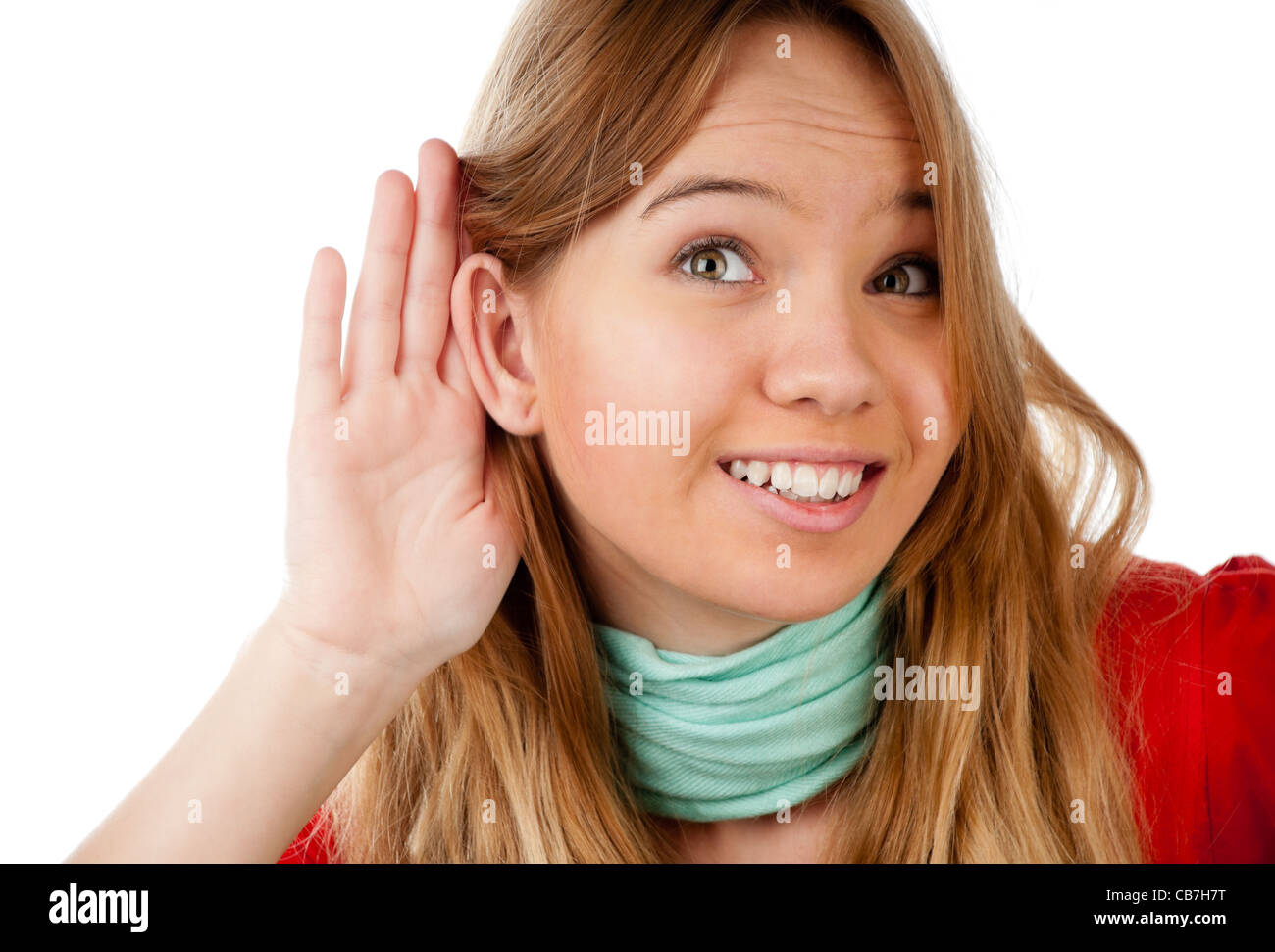 beautiful teenage girl, with hand at her ear, hearing something ...