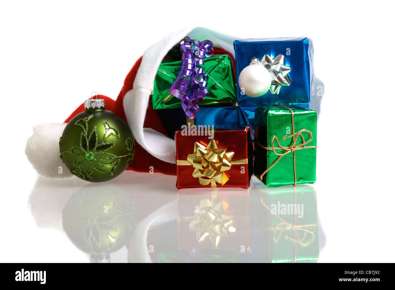 Christmas Decorations with small gifts in a santa hat isolated on white ...