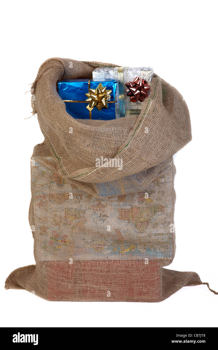 Jute sack full of Christmas gifts isolated on white background Stock ...