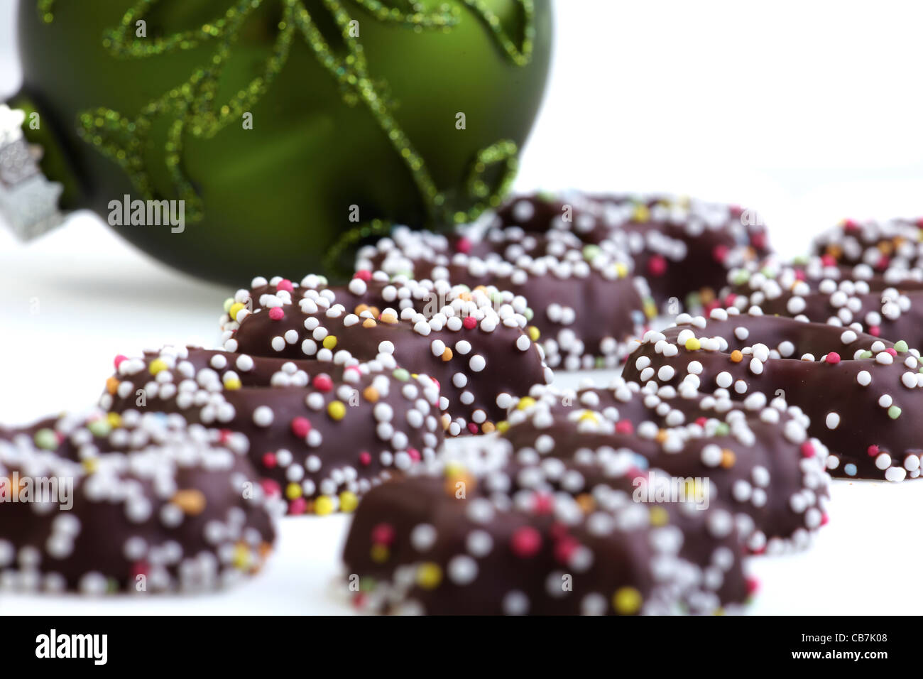 Many Sugar curls and a green christmas bauble isolated on white ...