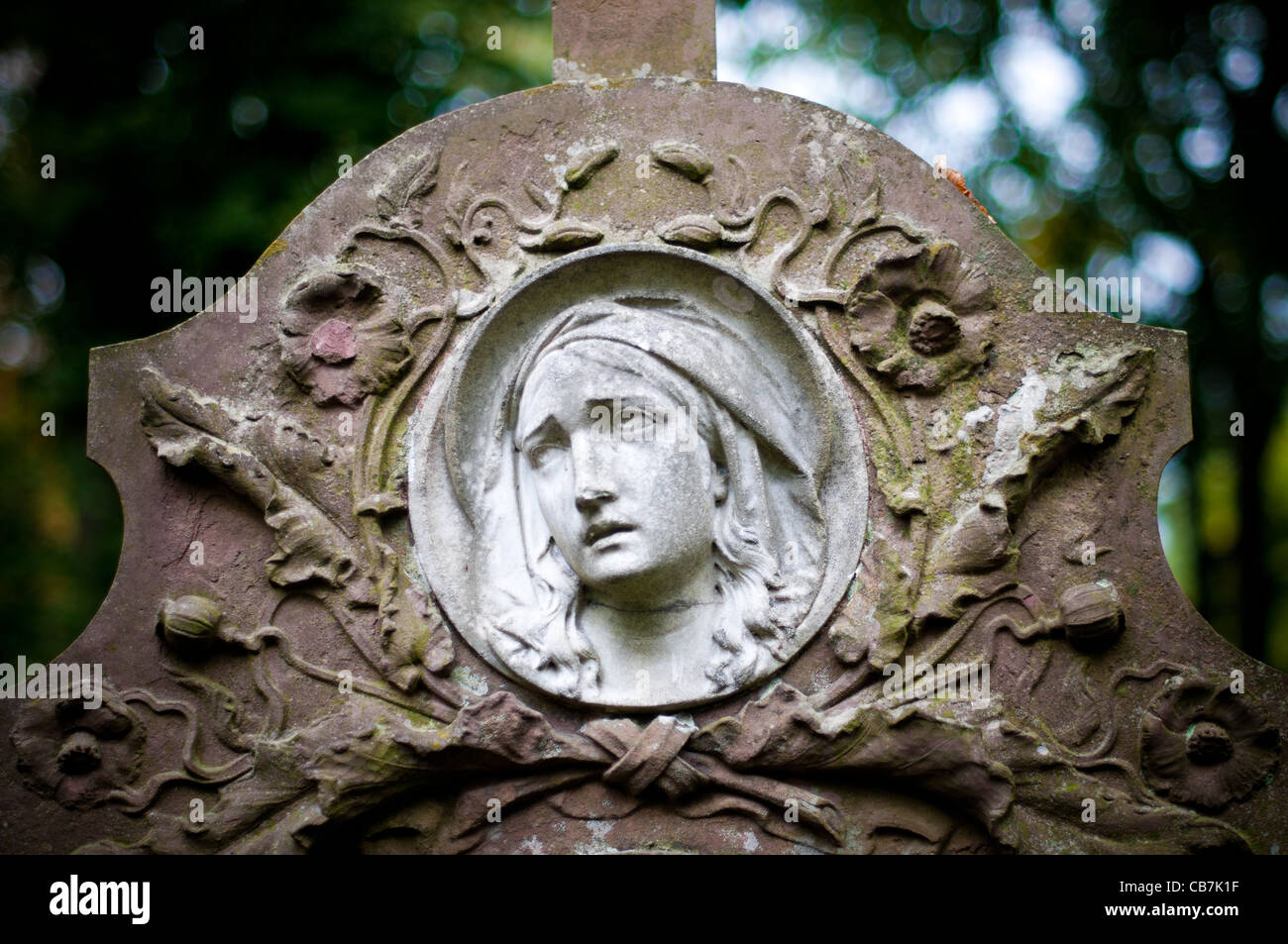old beautiful tombstone with carved woman face Stock Photo - Alamy