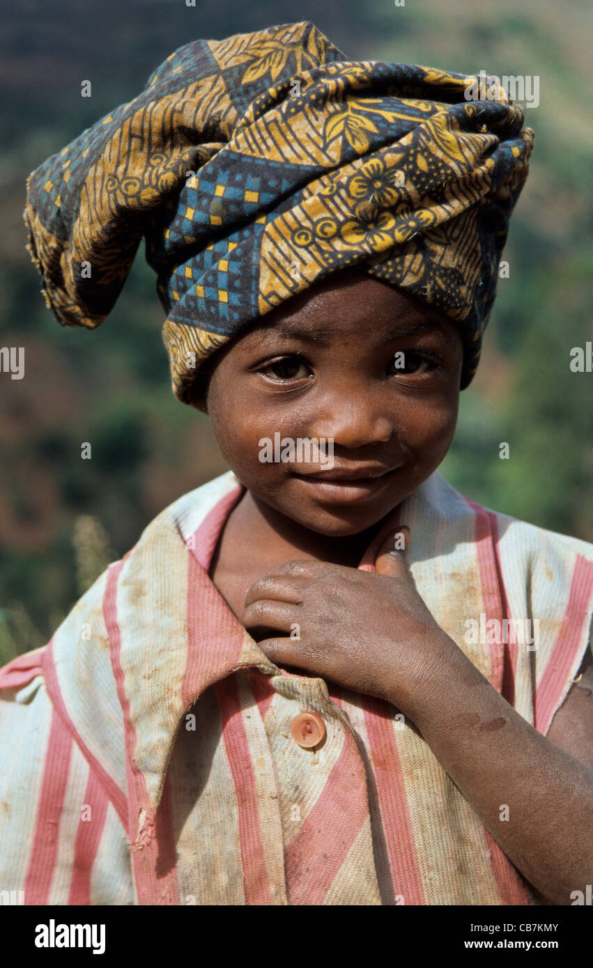 Young girl with a Kanga, the traditional cloth, wrapped around her head ...
