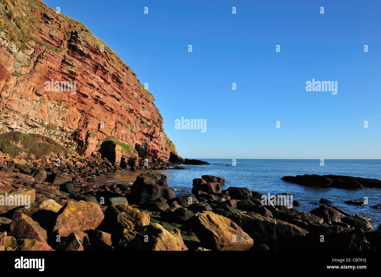 Coastal scene of red sandstone cliffs at Auchmithie, Angus, Scotland ...