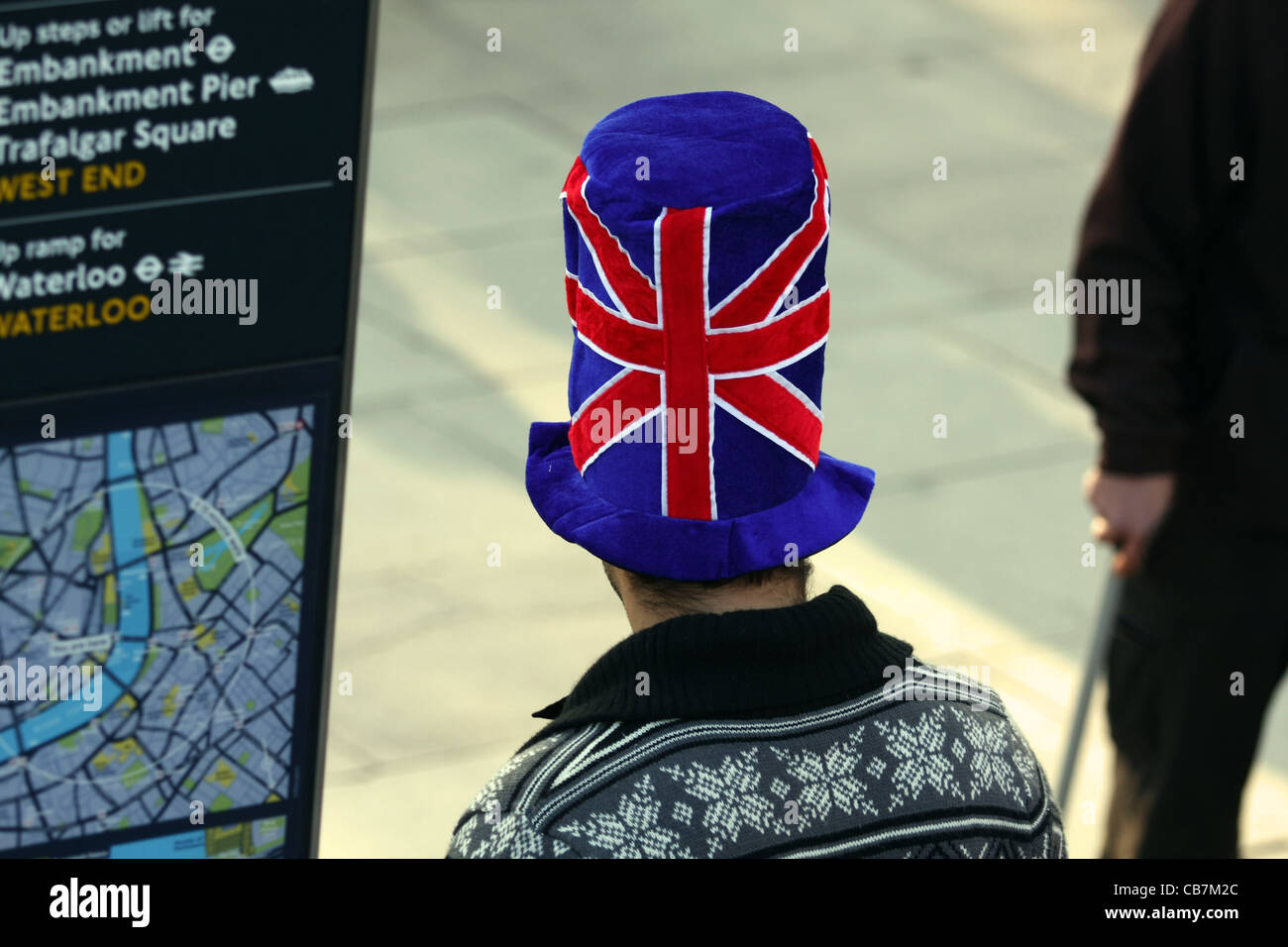 a male wearing a union flag top hat in London;s Westminster, with a ...
