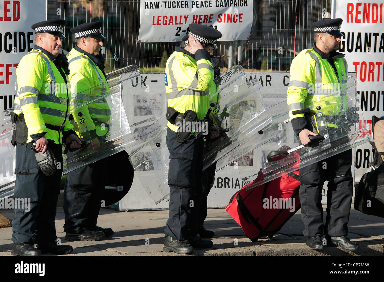 Police on mutual aid from UK police forces carry riot shield through ...