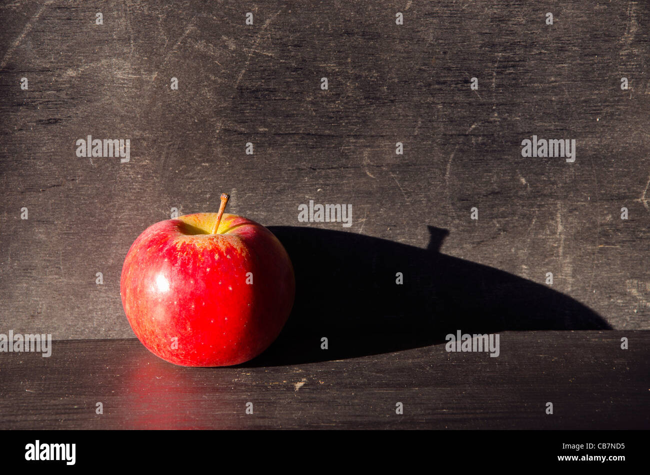 red apple on black table and evening shadow Stock Photo - Alamy
