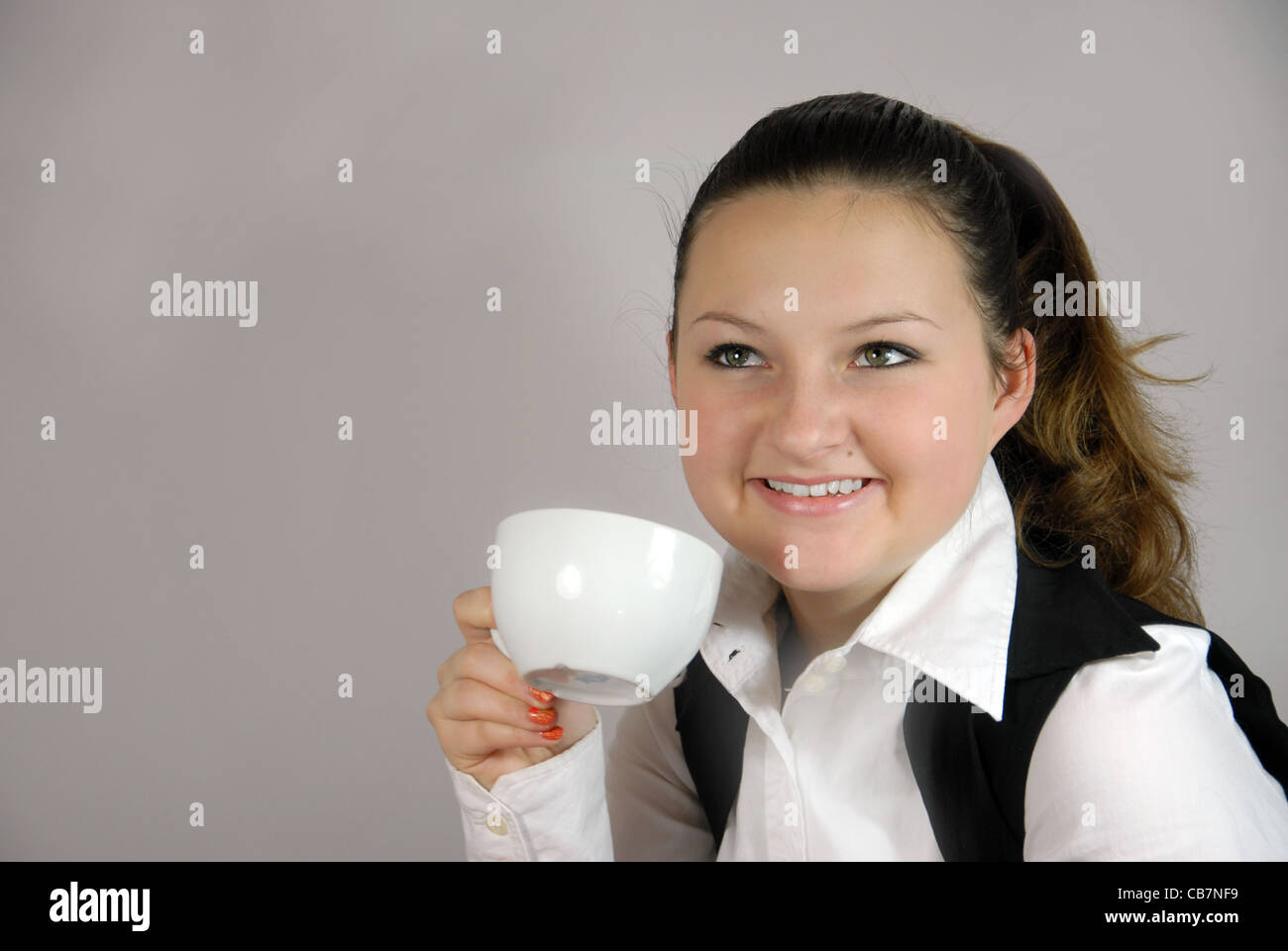young woman office worker on break drinking coffee operator Stock Photo ...