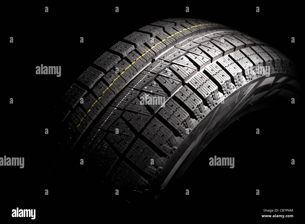 Modern winter car tyre. Horizontal composition. Low key Stock Photo - Alamy