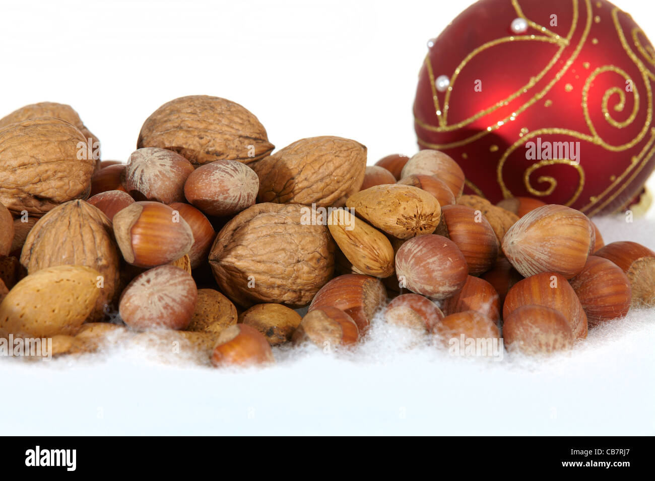 Nuts composition of hazelnuts and walnuts with a red christmas tree ...