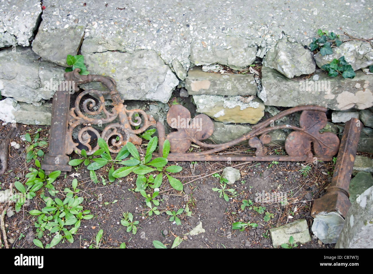 Parts of a old and rusty decorative railing that once surrounded a ...