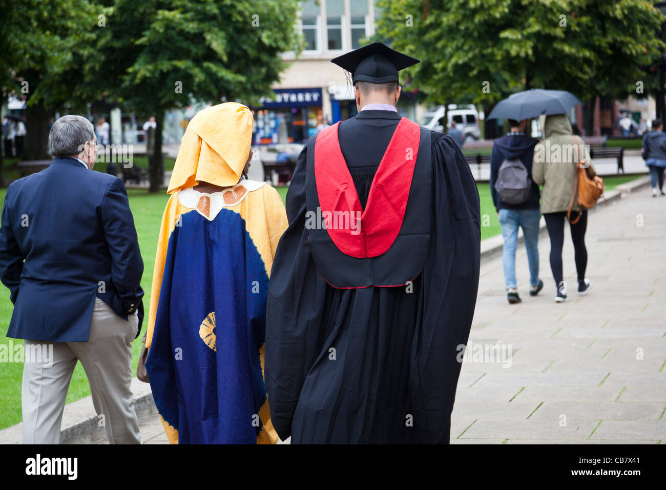 Graduate student walks with lady dressed in African national costume ...