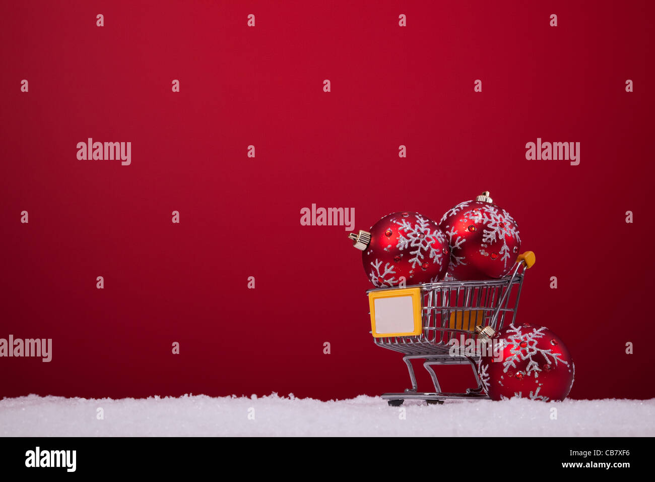 christmas balls in a shopping cart over a red background Stock Photo ...