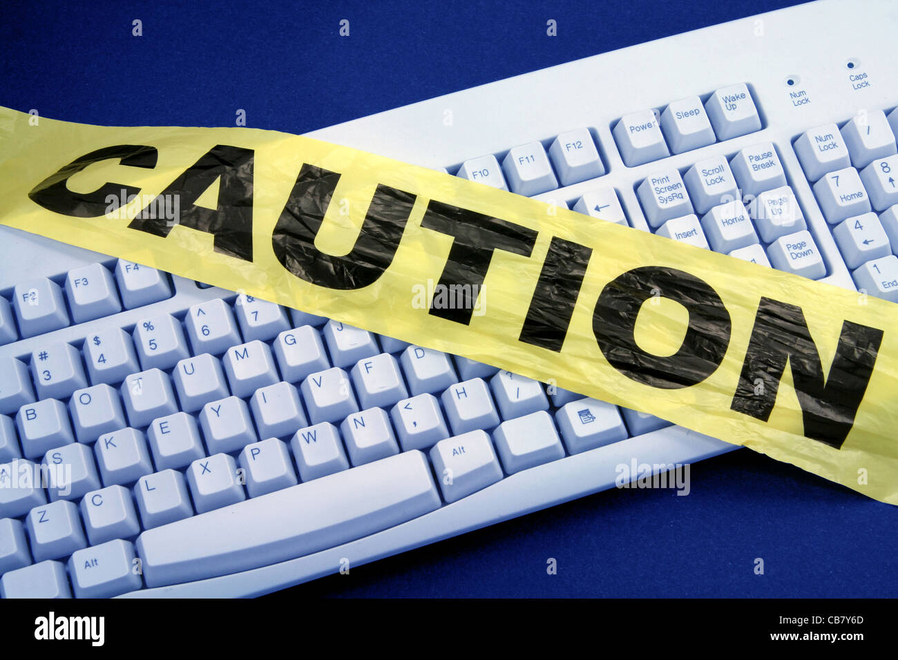 plastic caution tape and keyboard, computer crime Stock Photo - Alamy