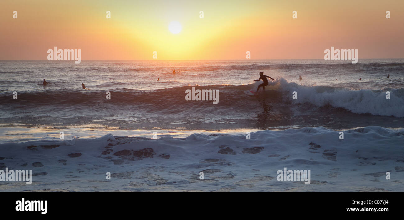 Surfing the waves at Widemouth Bay in Cornwall Stock Photo - Alamy