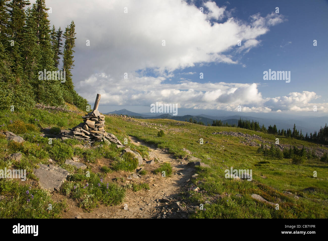 Cairn marking the Pacific Crest Trail which traverses alpine meadows ...
