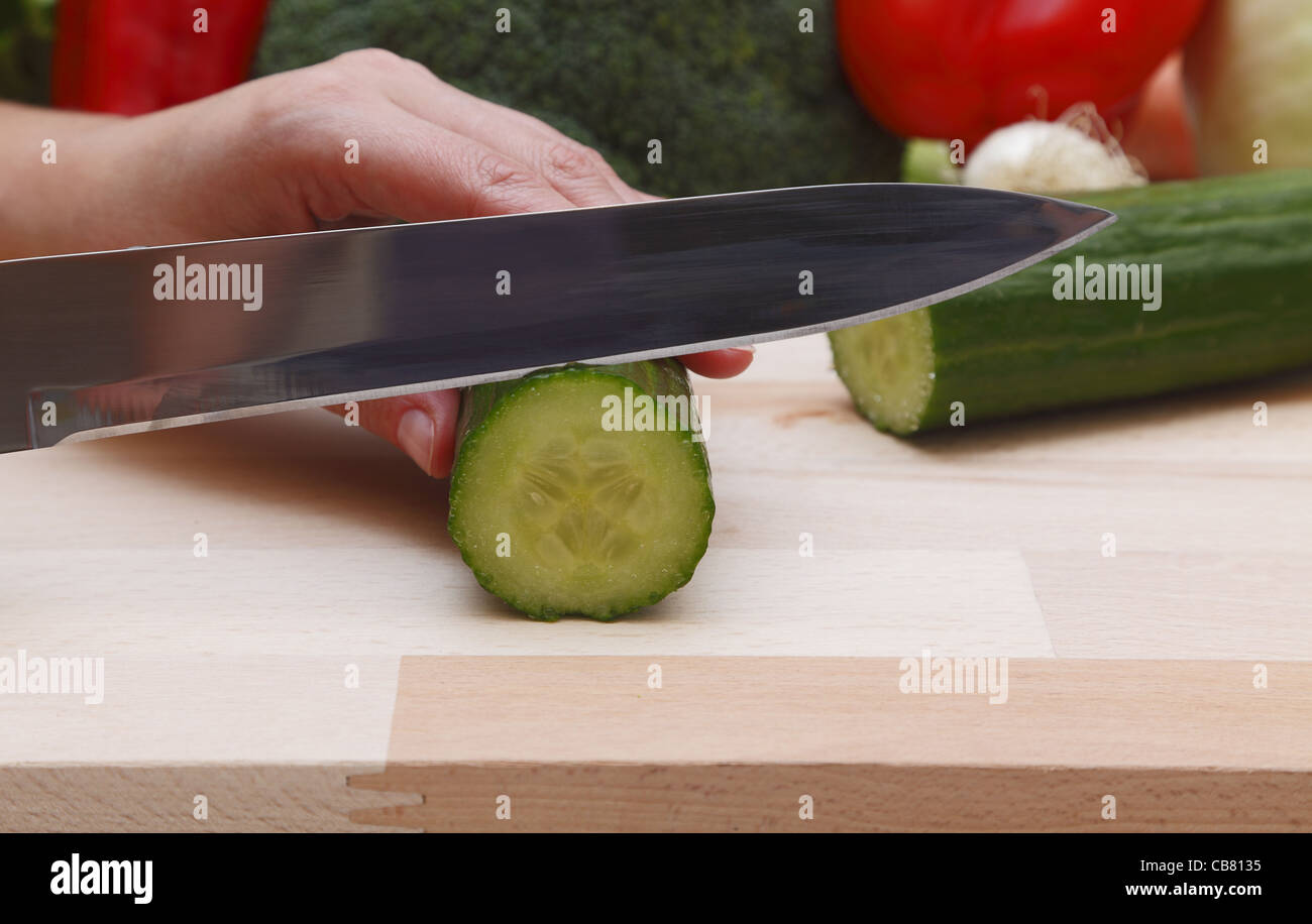 Close-up image of a knife chopping a cucumber Stock Photo - Alamy