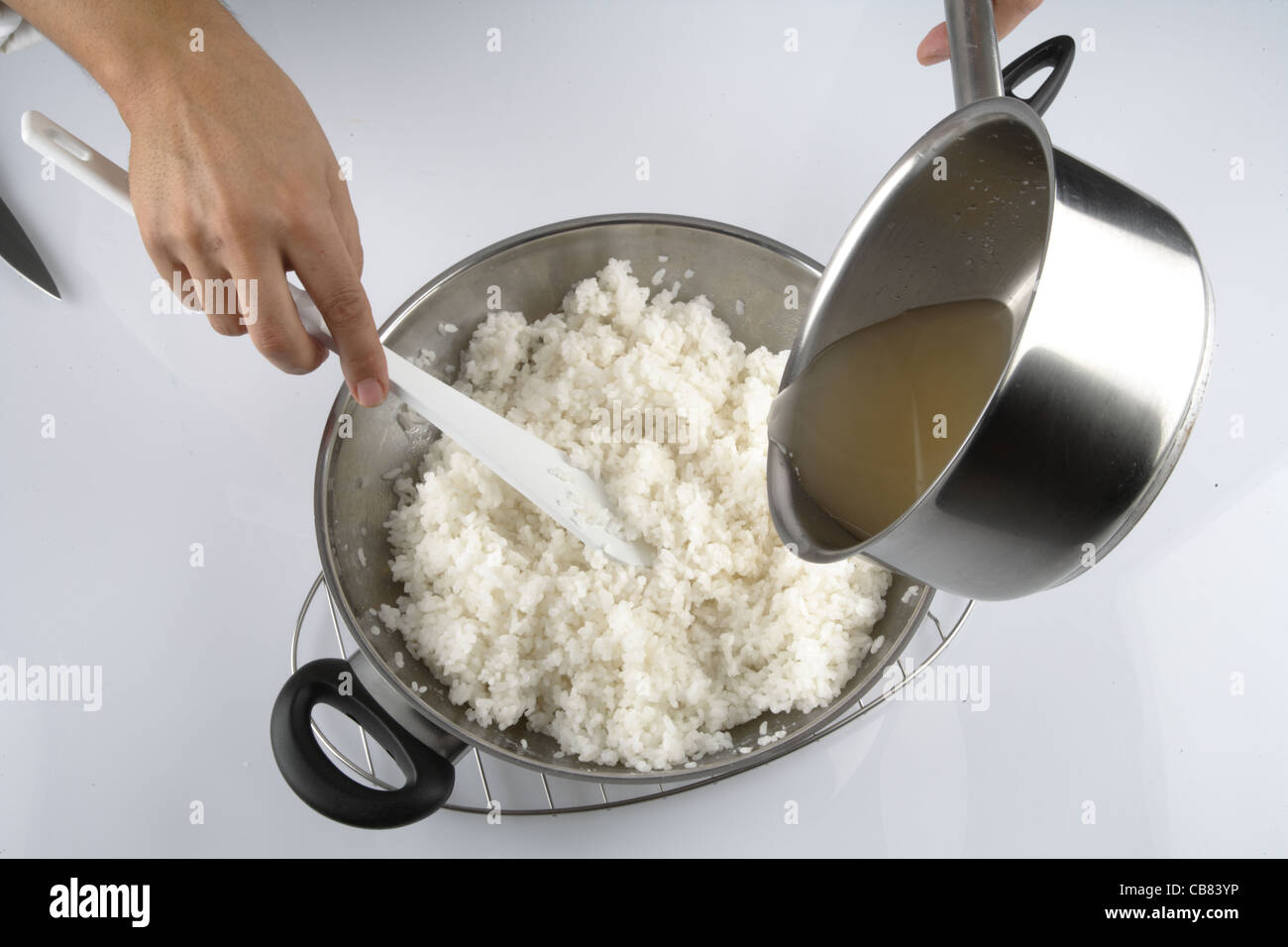 Pouring vinegar with sugar and salt over rice Stock Photo - Alamy