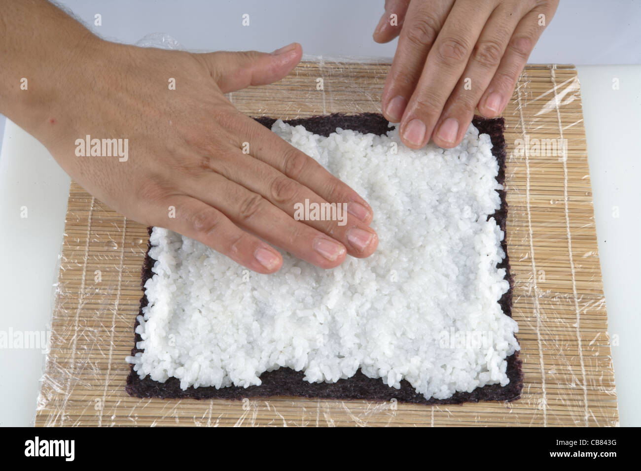 Putting rice on Nori sheet Stock Photo - Alamy