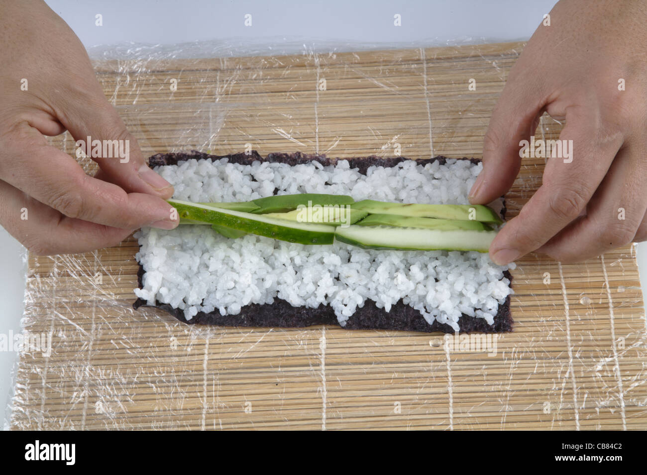 Putting cucumber over rice Stock Photo - Alamy