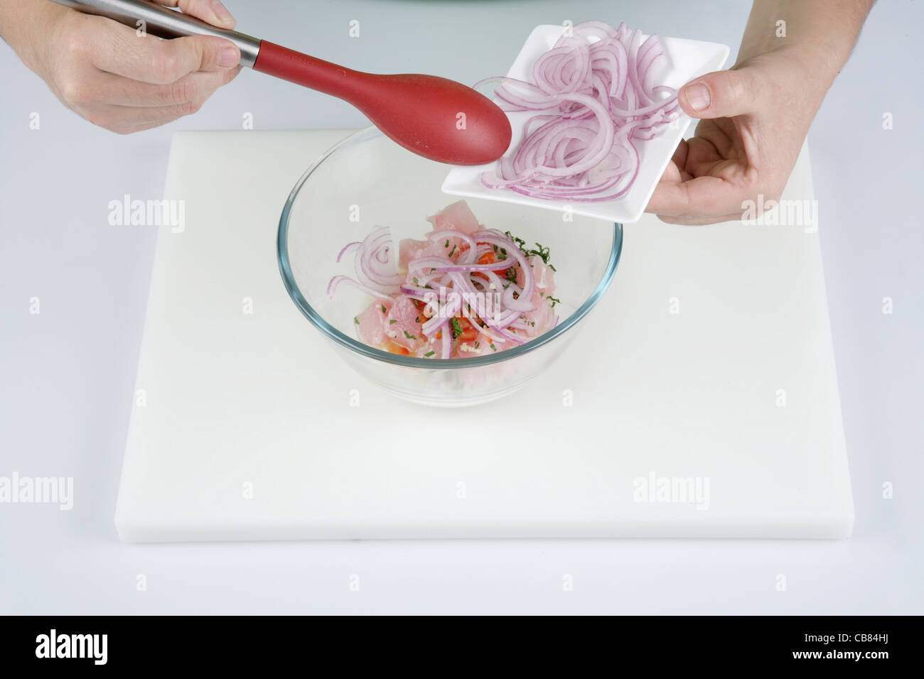 Adding red onion Stock Photo - Alamy