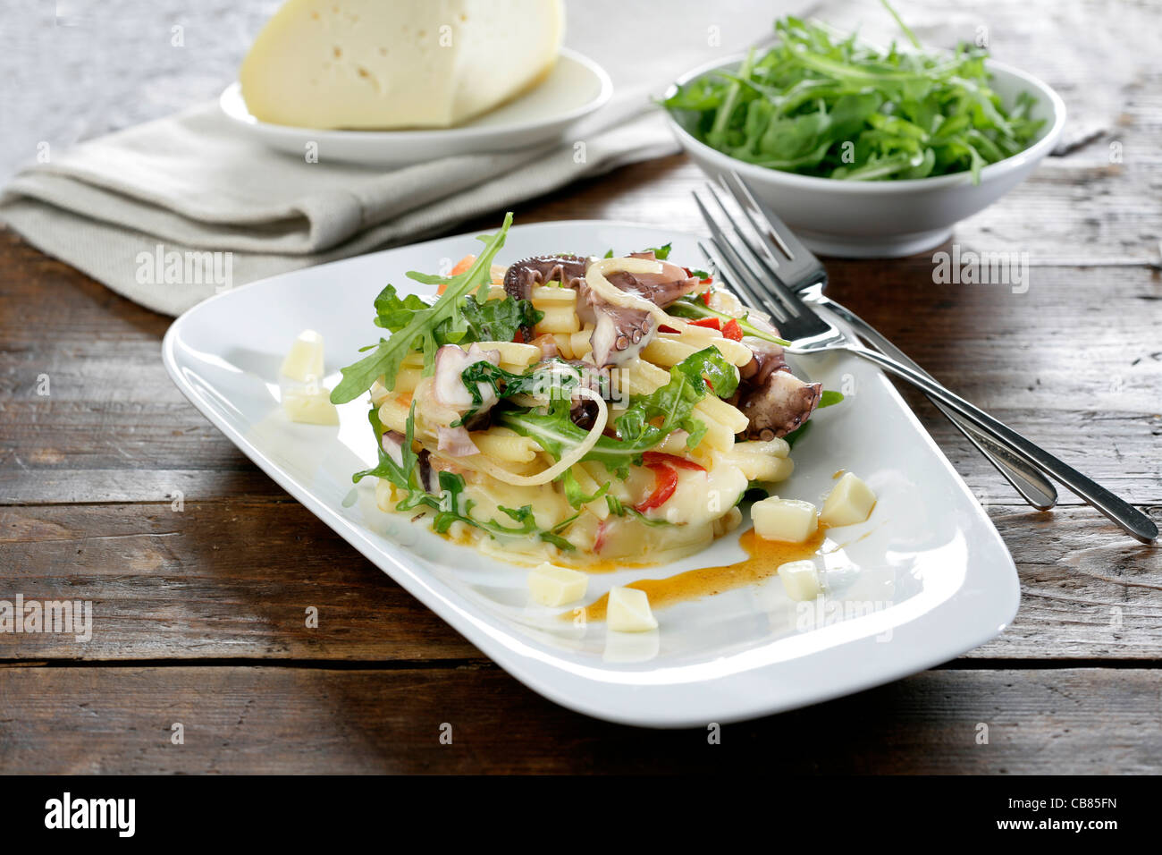 Sauteed octopus with pasta and cheese Stock Photo - Alamy