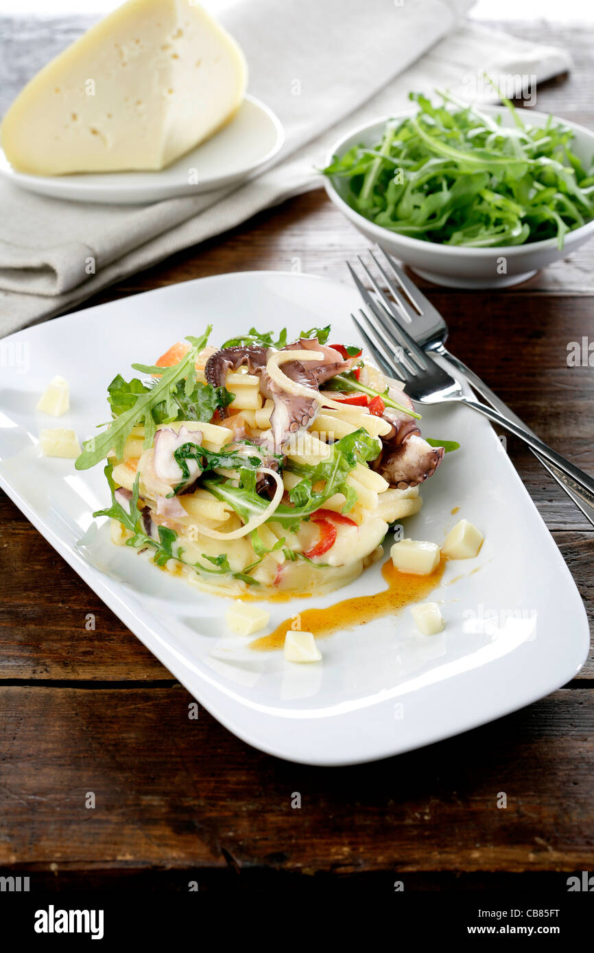 Sauteed octopus with pasta and cheese Stock Photo - Alamy