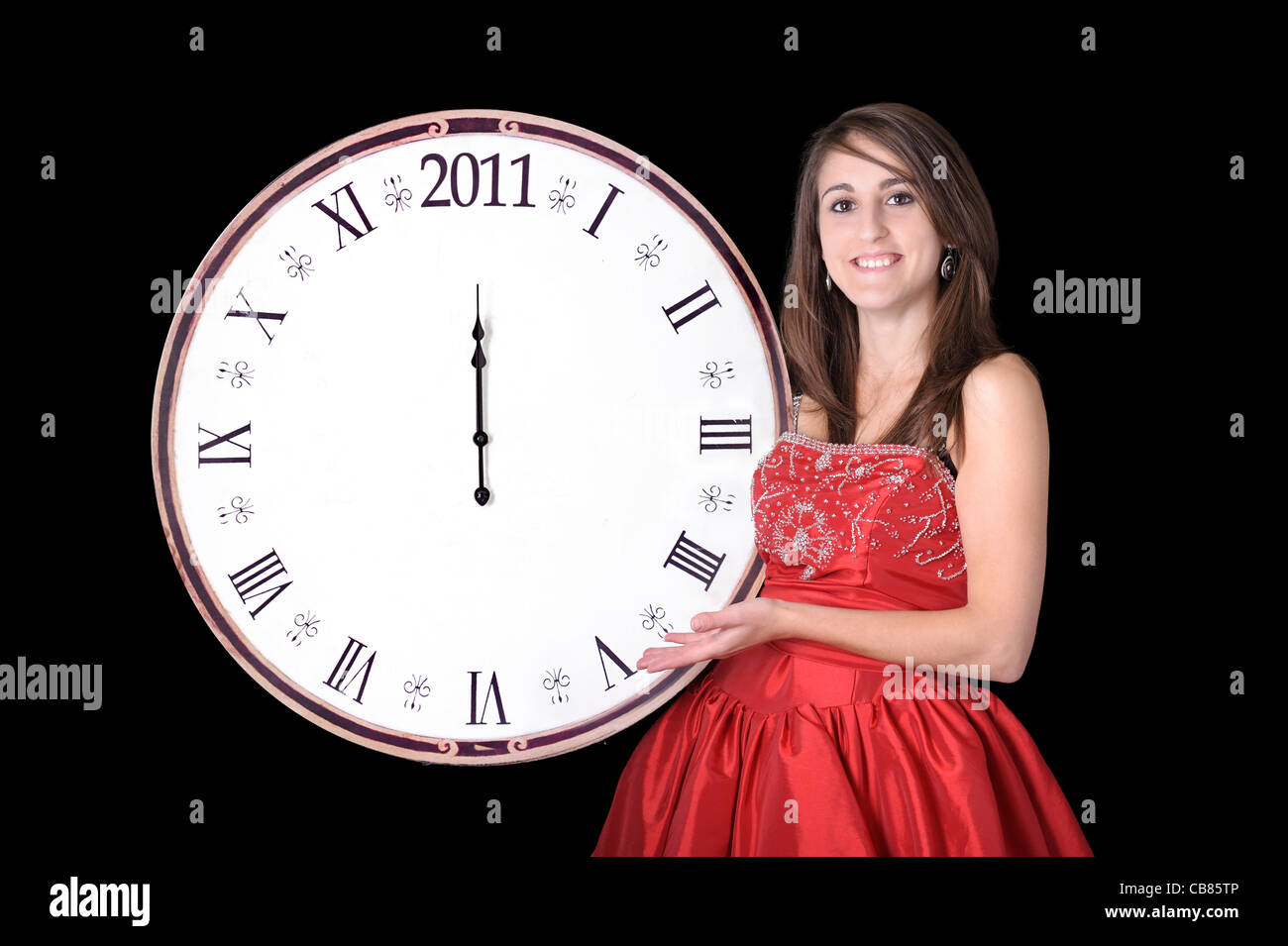 young woman in evening dress with midnight clock, isolated on black ...