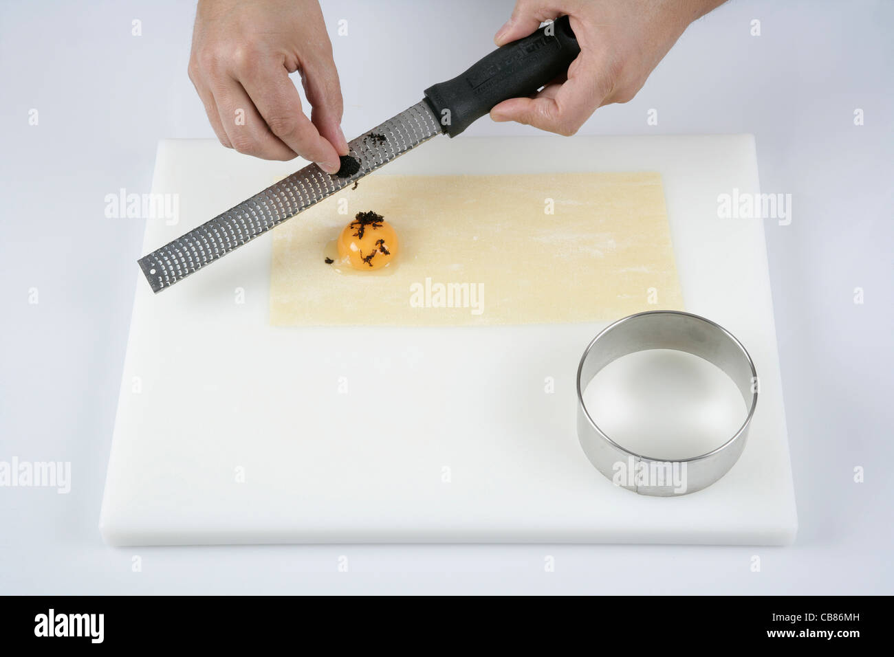 Grating truffles on egg yolk Stock Photo - Alamy
